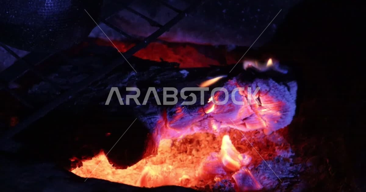 Preparing to prepare hot drinks, close-up of burning coal at night time ...
