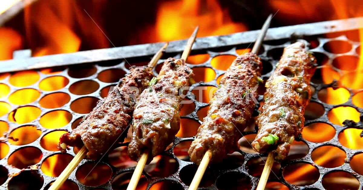 Close-up photography of grilling Arabic kofta skewers over a burning ...