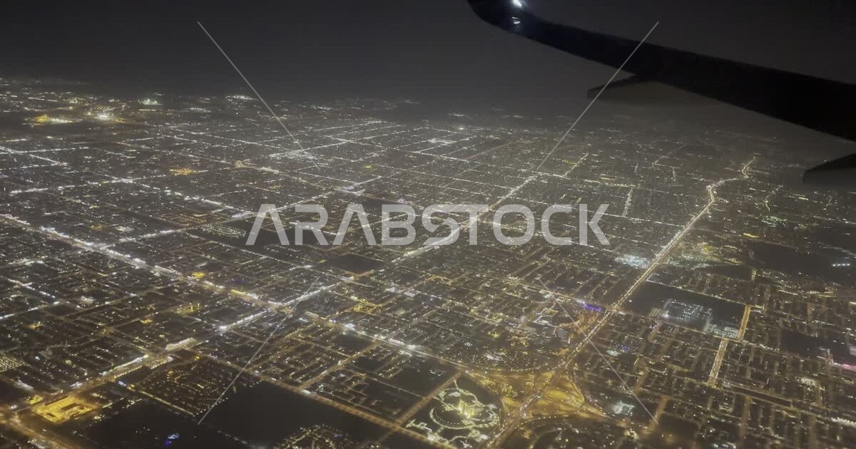 An airplane wing flying in the sky at night, aerial photography from ...