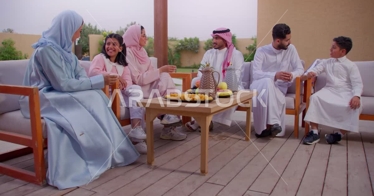 A Saudi Gulf Arab family sitting in one of the chalets, family cohesion ...