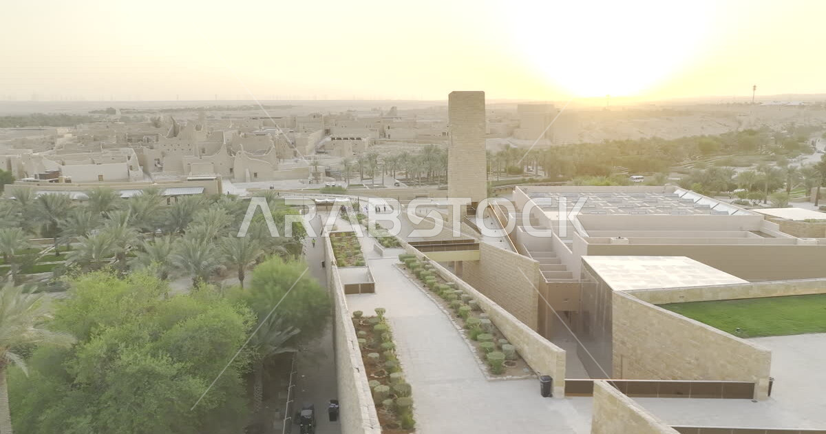 Ancient mud buildings and houses, planting plants and palm trees, the ...