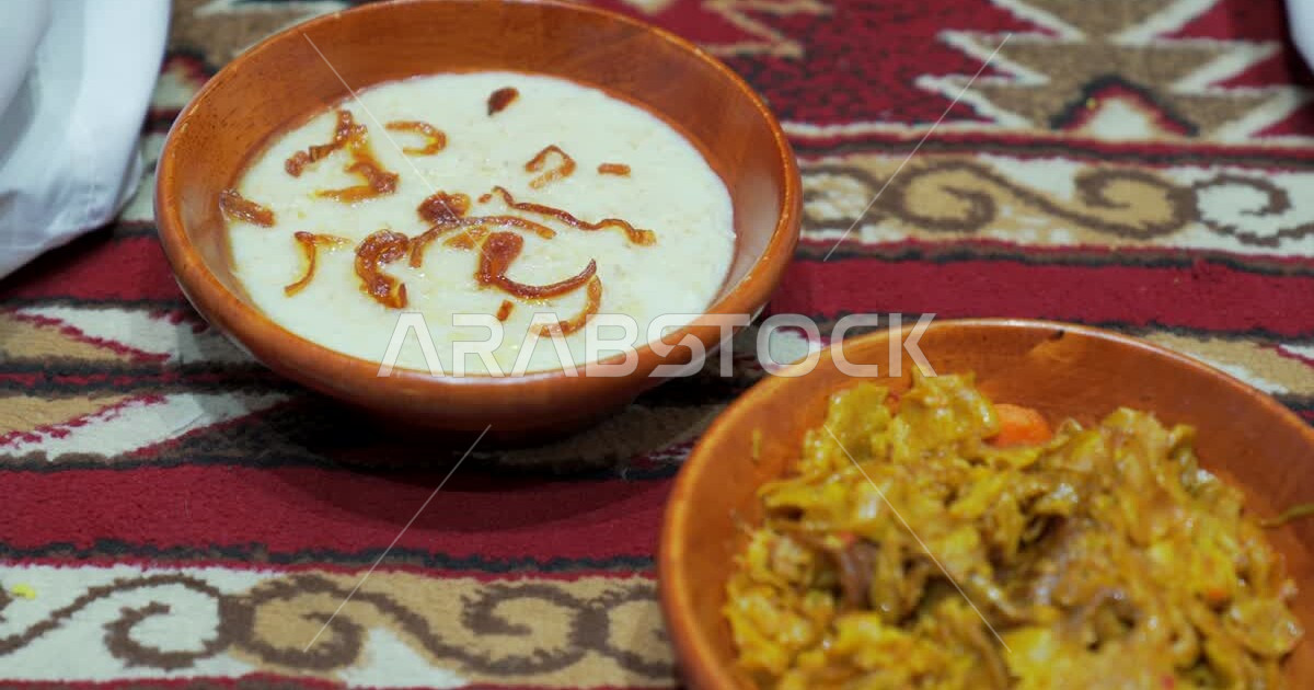 A Saudi Arabian Gulf man at the dining table, eating by hand, sitting ...