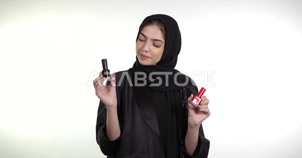 Portrait of a happy Saudi Arabian Gulf woman, who uses a set of ...