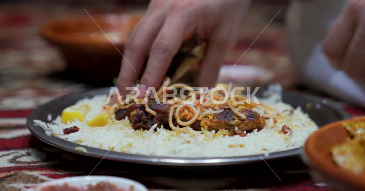 Two young Saudi Arabian Gulf men gathered at the dining table, Ramadan ...