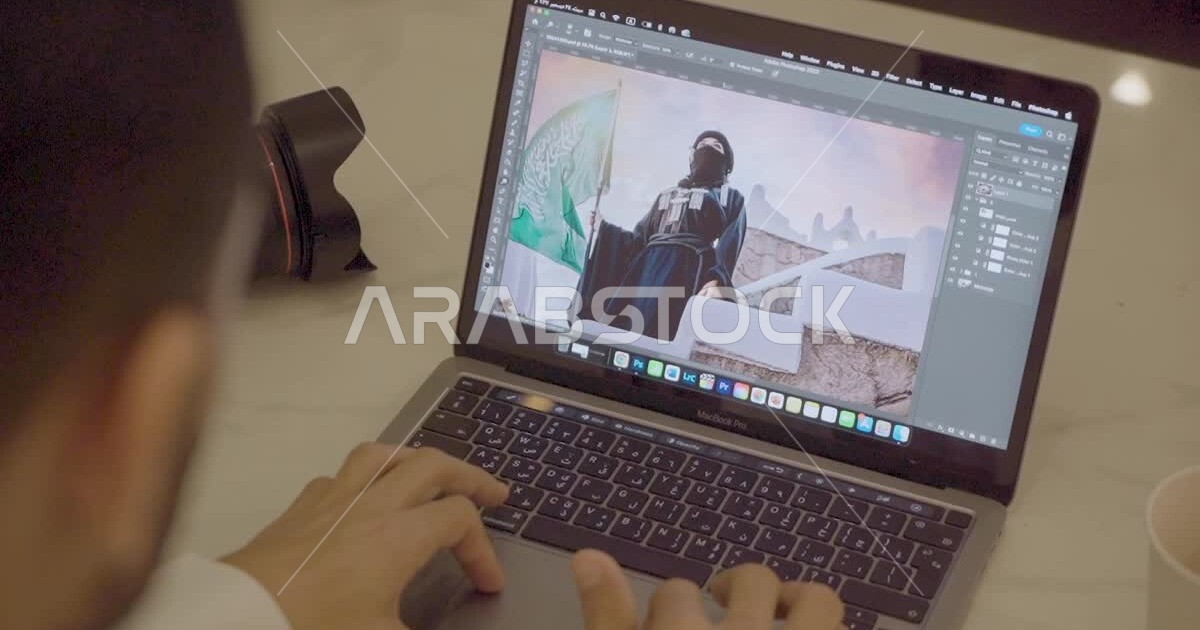 Editing photos using electronic applications, a Saudi Gulf Arab ...