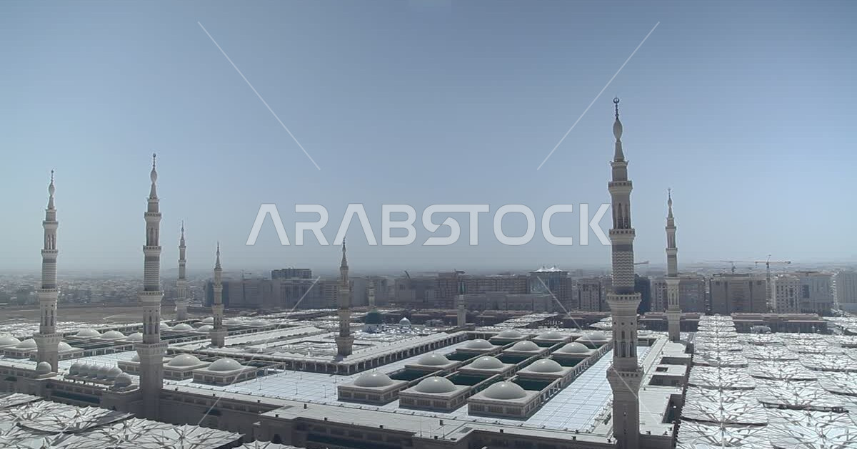 Electronic solar umbrellas during the day, holy Islamic landmarks, a ...