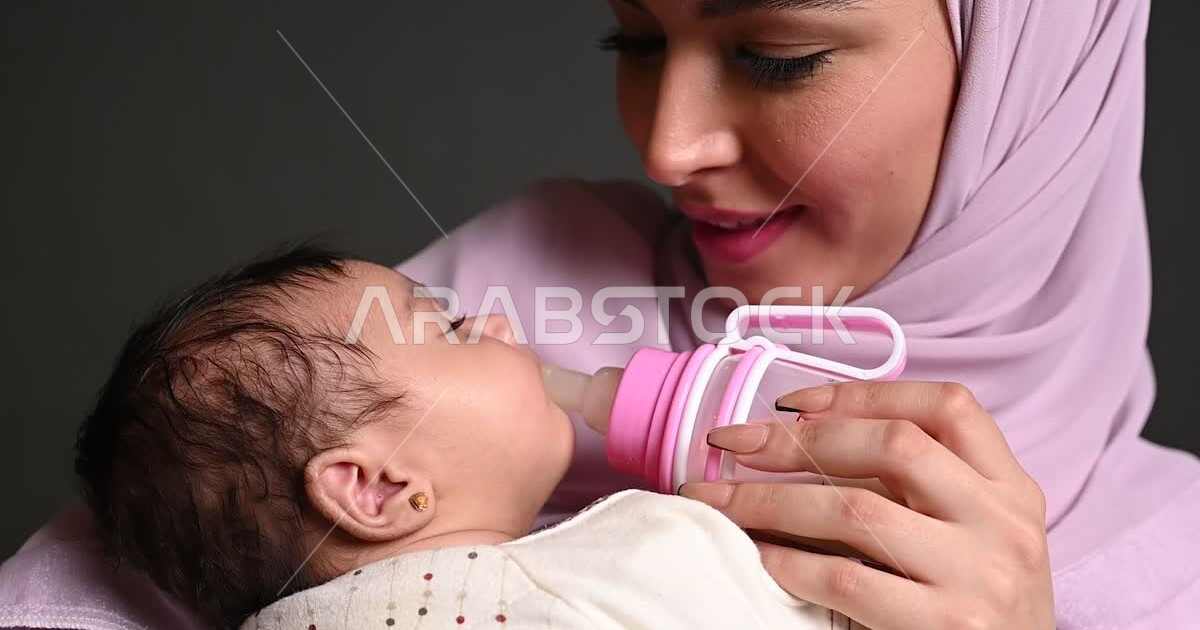 The concept of child care, a close-up portrait of a veiled Saudi ...