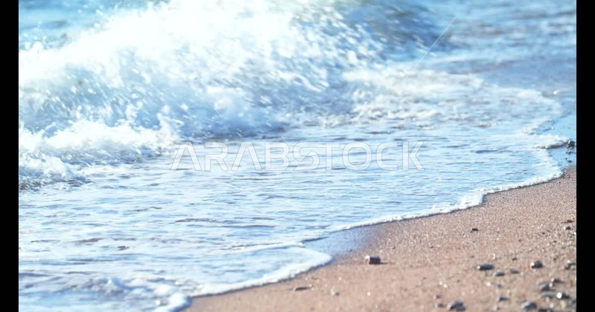 Coastal beaches in the Arabian Gulf, clashing sea waves, creating foam ...