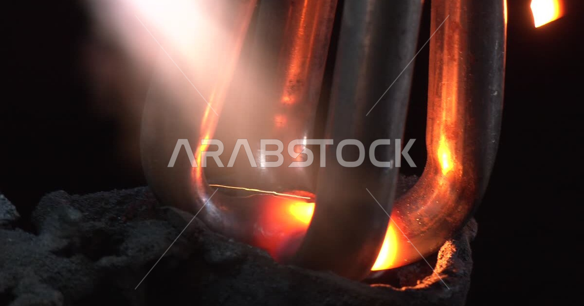 Close-up photography of a Saudi Arabian Gulf blacksmith welding iron ...