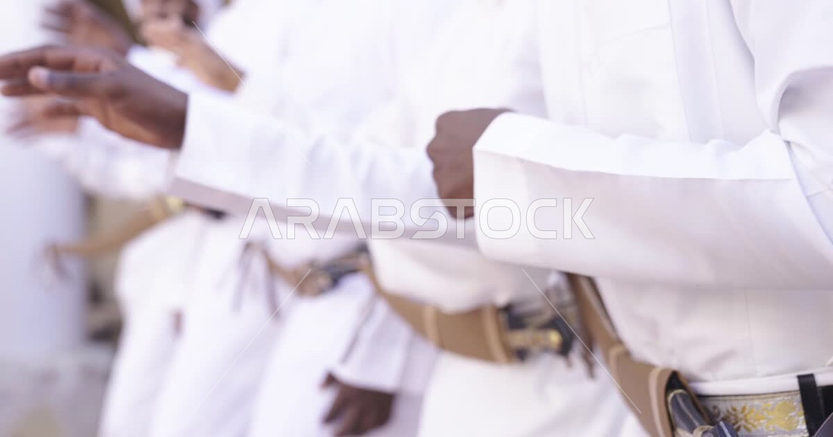 .A group of Saudi Gulf Arab men dancing with gestures of joy and ...