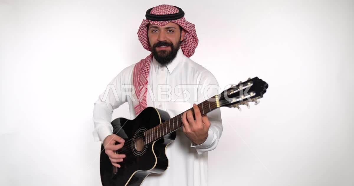 Portrait of a young Saudi Arab from the Gulf playing the guitar (a ...