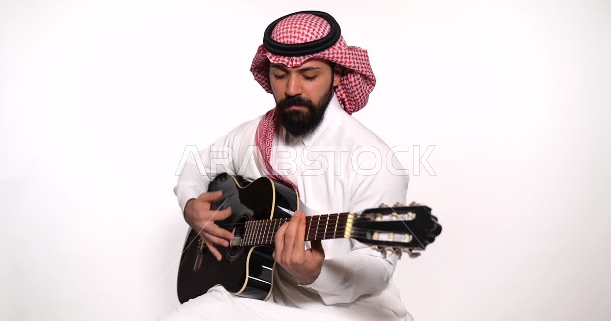 Portrait of a young Saudi Arab from the Gulf playing the guitar (a ...