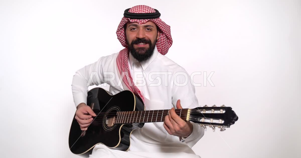 Portrait of a young Saudi Arab from the Gulf playing the guitar (a ...