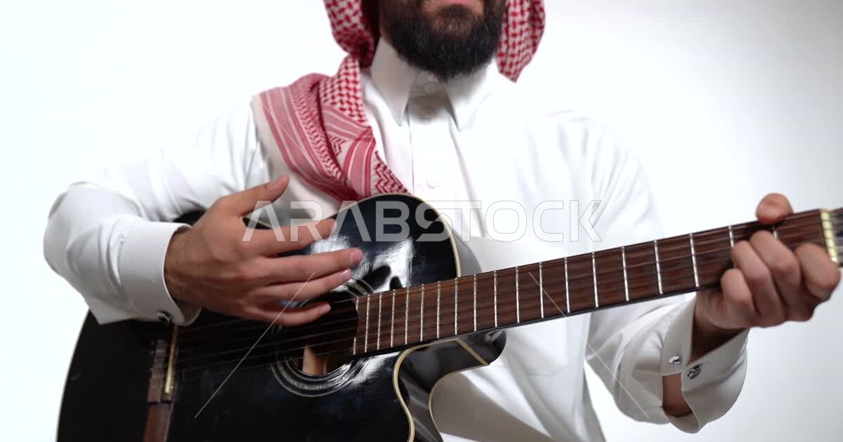 Portrait of a young Saudi Arab from the Gulf playing the guitar (a ...