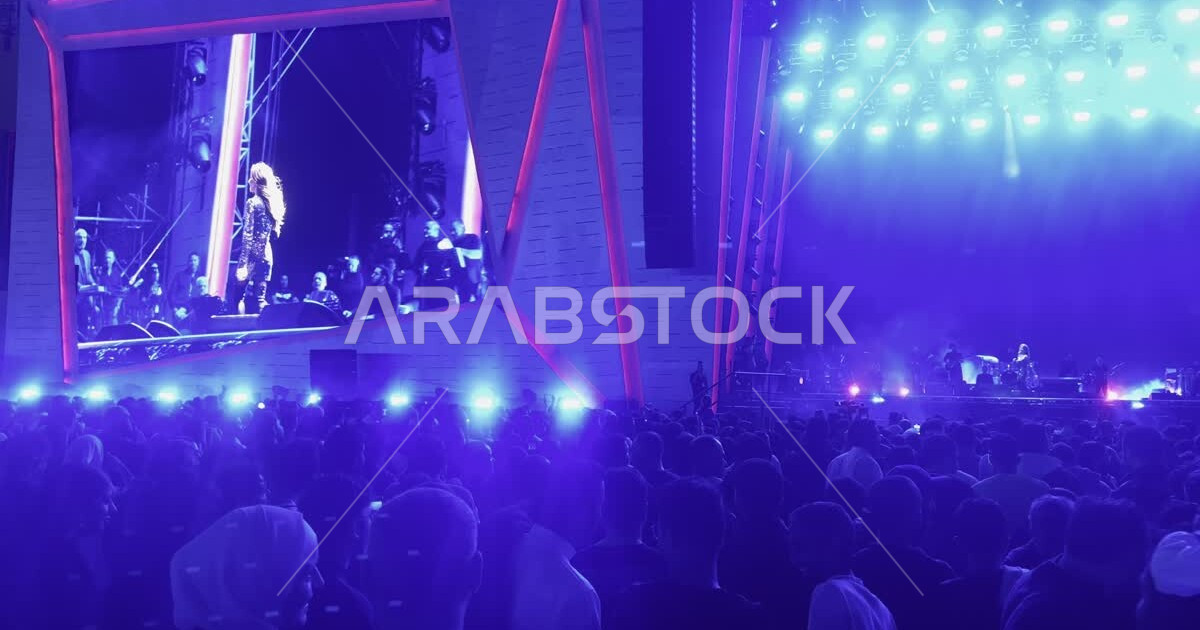 Riyadh Season events, a group of fans using mobile phones to photograph ...