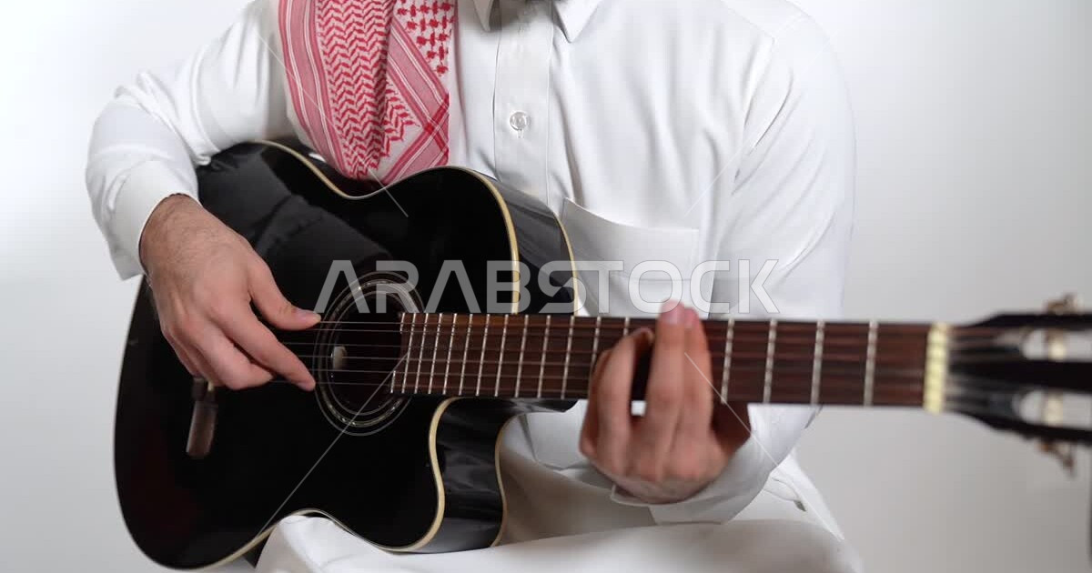 Portrait of a young Saudi Arab from the Gulf playing the guitar (a ...
