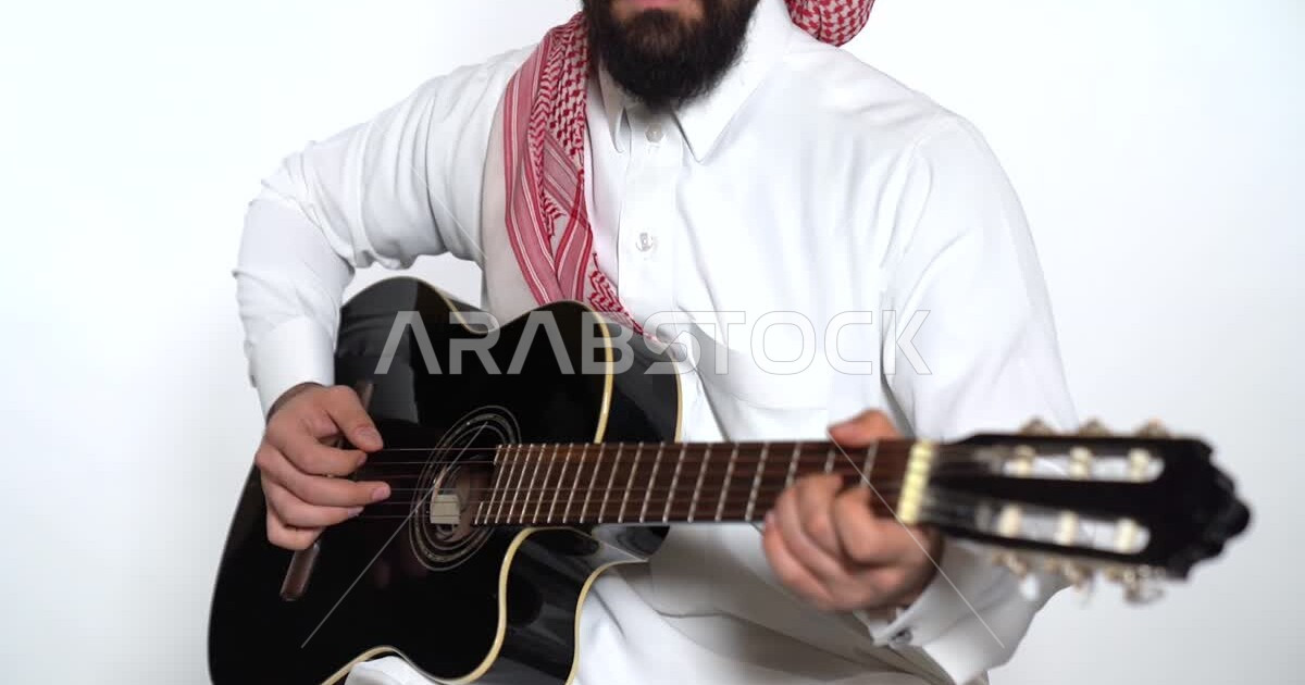 Portrait of a young Saudi Arab from the Gulf playing the guitar (a ...