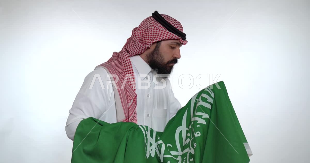 A Saudi man holds the Saudi flag on Saudi National Day, Saudi National ...