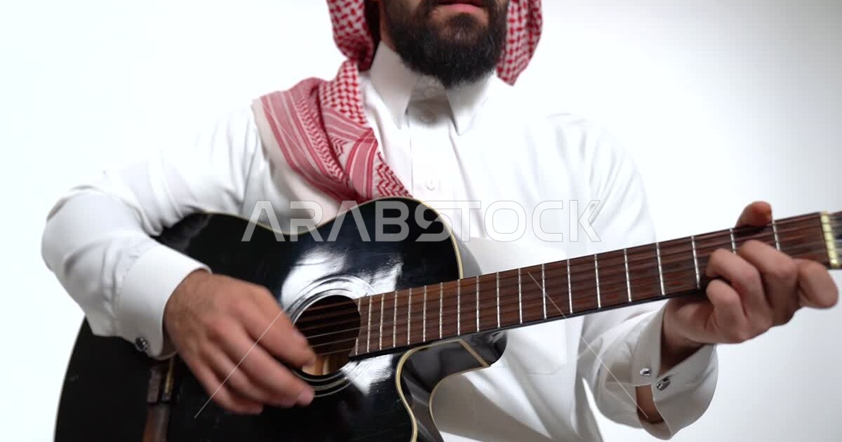 Portrait of a young Saudi Arab from the Gulf playing the guitar (a ...