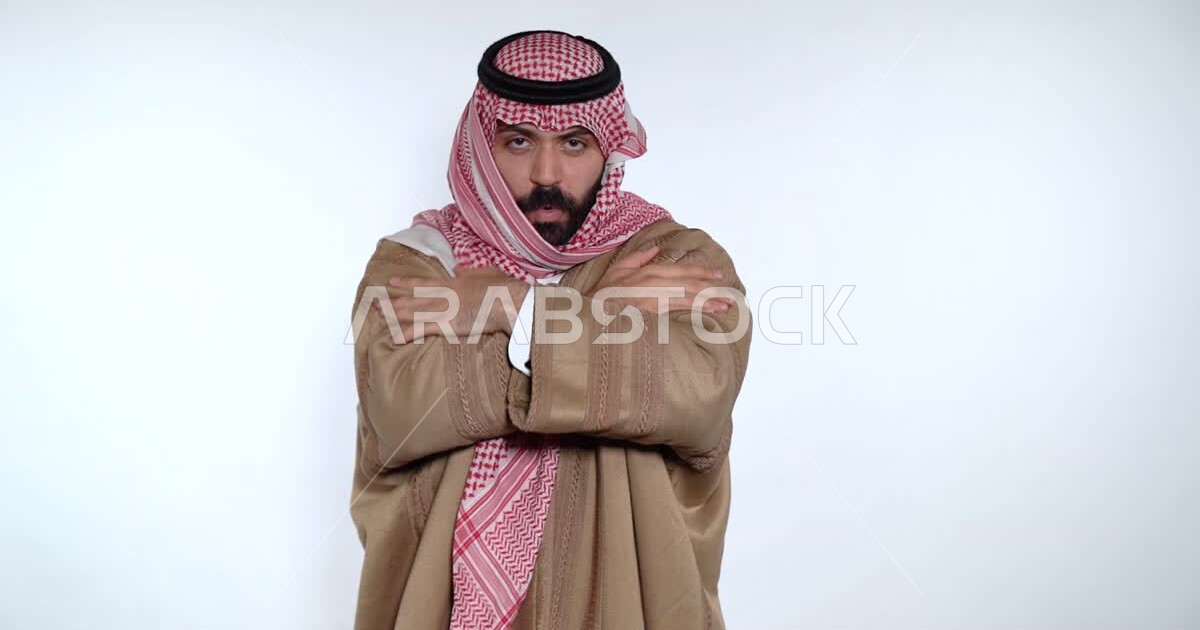 Portrait of a Saudi Gulf man with face gestures indicating feeling cold ...