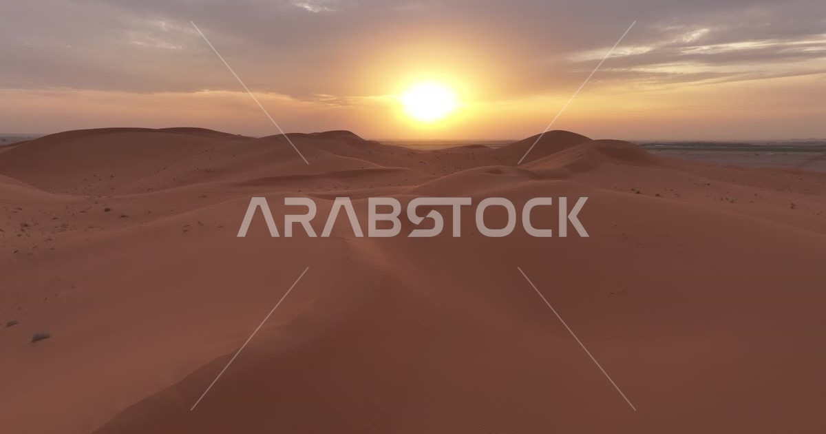 Enjoying the sunset view in the desert, soft golden sand and dunes in ...