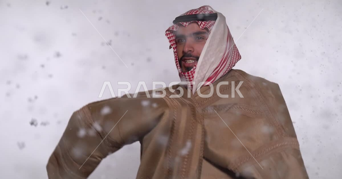 Portrait of a Saudi Gulf man with face gestures indicating feeling cold ...