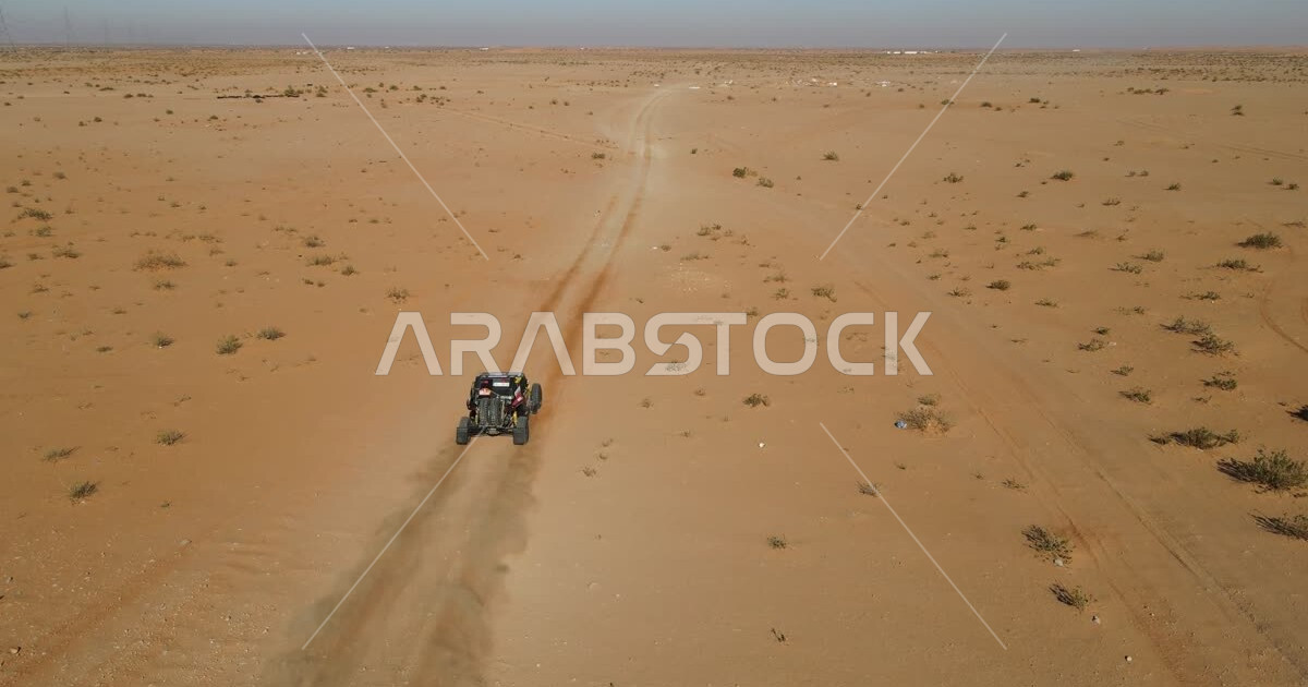 Soft golden sand, aerial photography of a racing car participating in ...