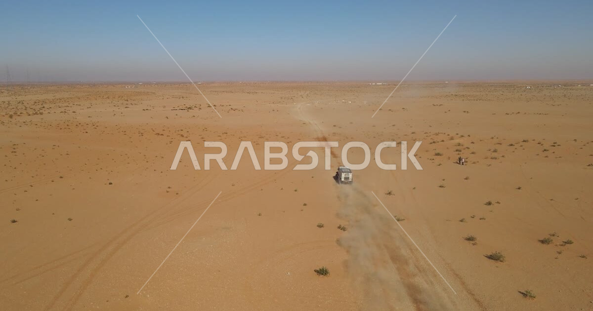 Driving four-wheel drive vehicles in the middle of the desert, soft ...