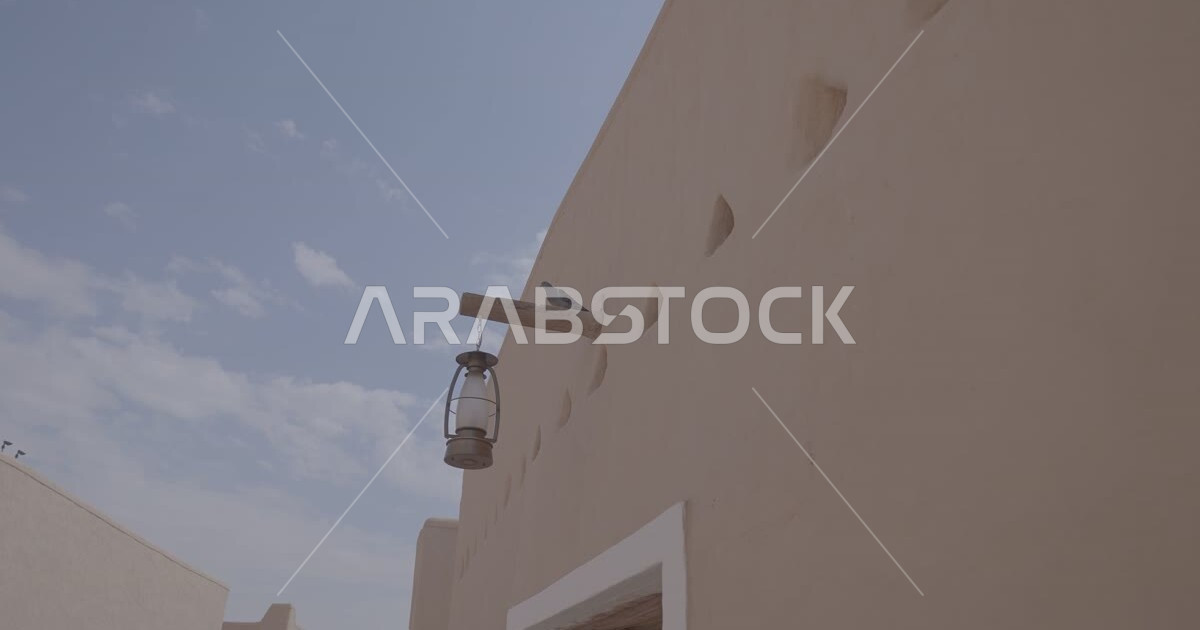 Our Day 1727 AD, a traditional metal lantern hung on the clay wall of ...