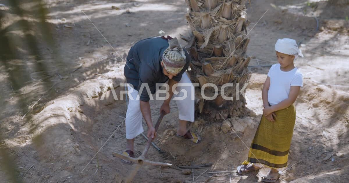Digging and preparing the land for seeding and watering it, a Saudi ...