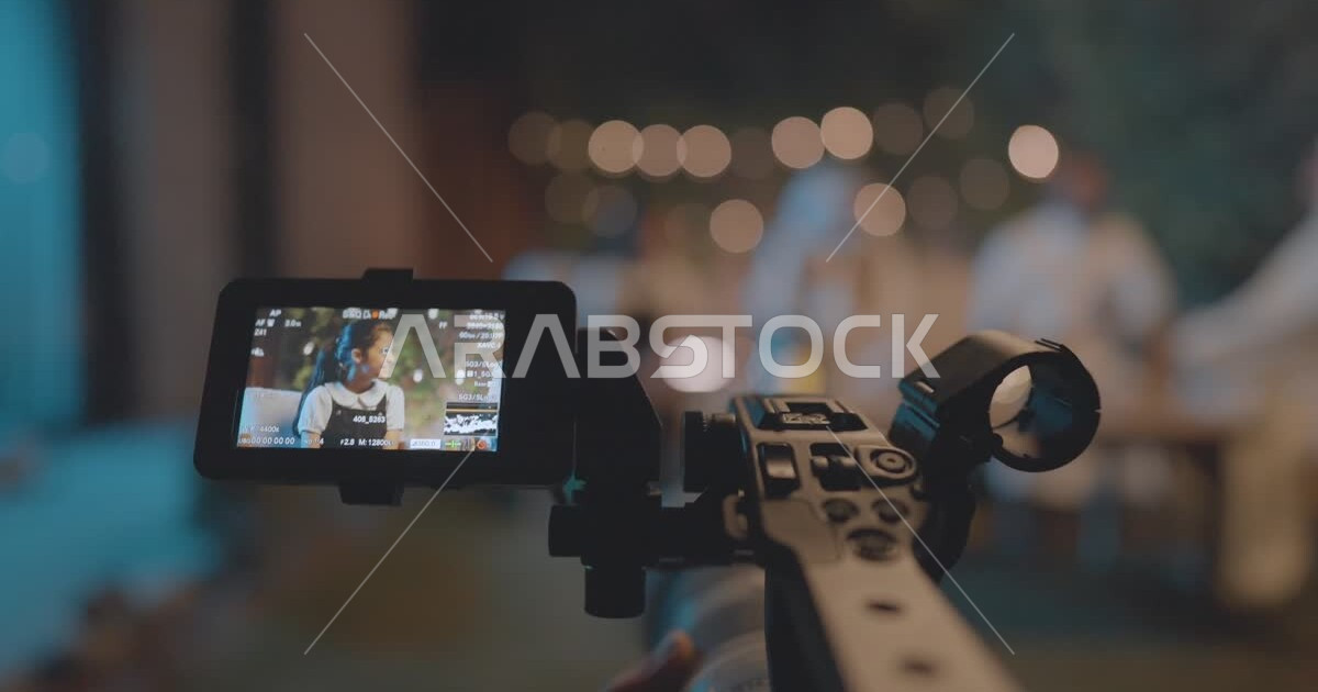 Behind the scenes concept, filming from behind the hand of a Saudi Gulf ...