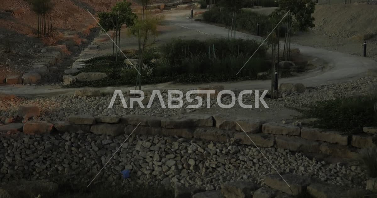 Green plants and trees between the rocky stones in Medina Park, an ...
