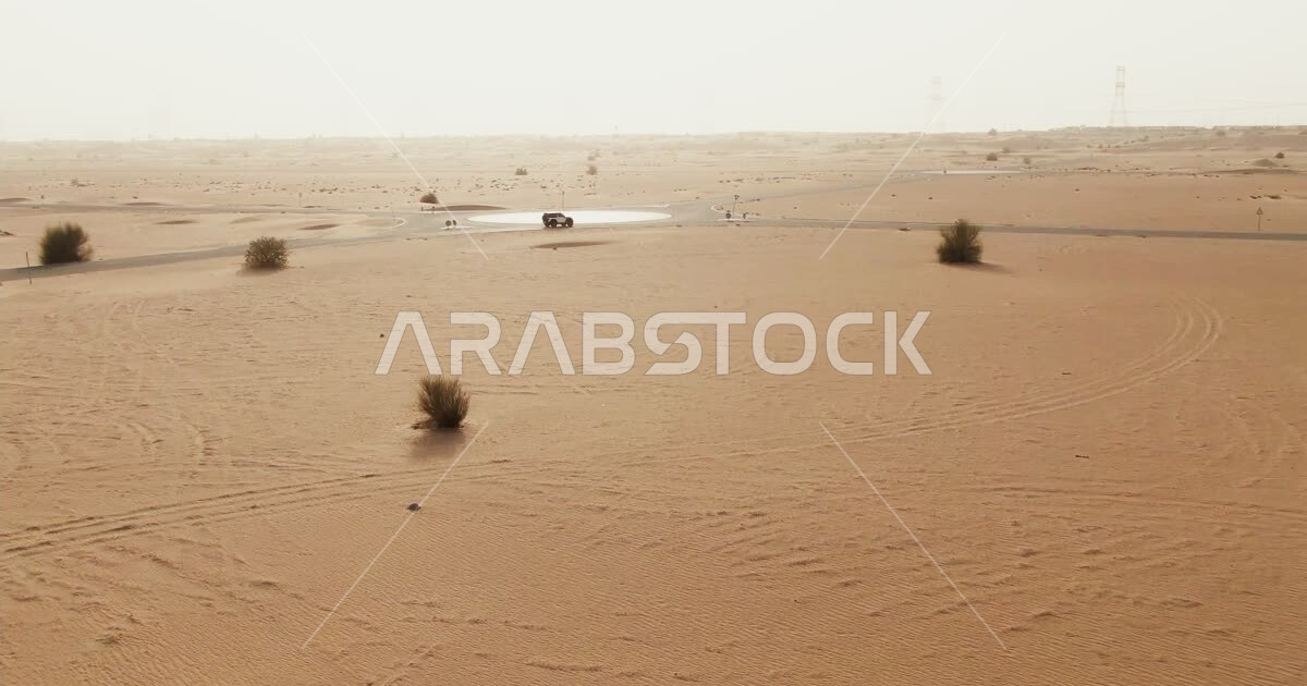 Driving a four-wheel drive vehicle in the middle of the desert, soft ...