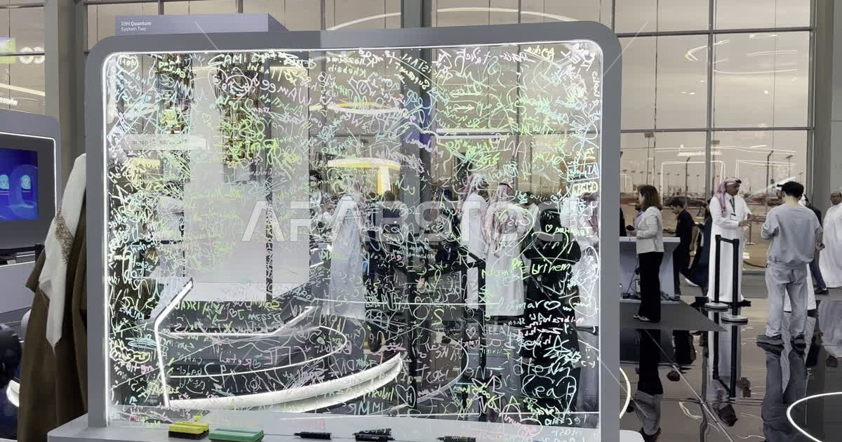 A transparent glass panel in the LEAP exhibition, writing a ...