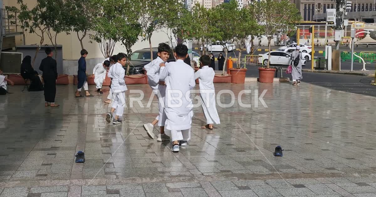 Feeling happy and happy, a group of Saudi Gulf Arab boys wearing ...