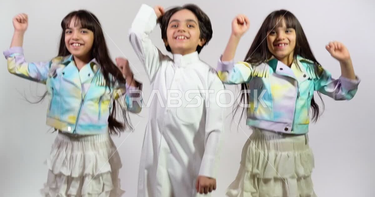 Portrait of three children of Saudi Gulf twins, face gestures ...
