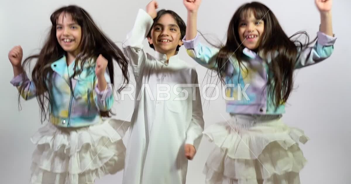 Portrait of three children of Saudi Gulf twins, face gestures ...