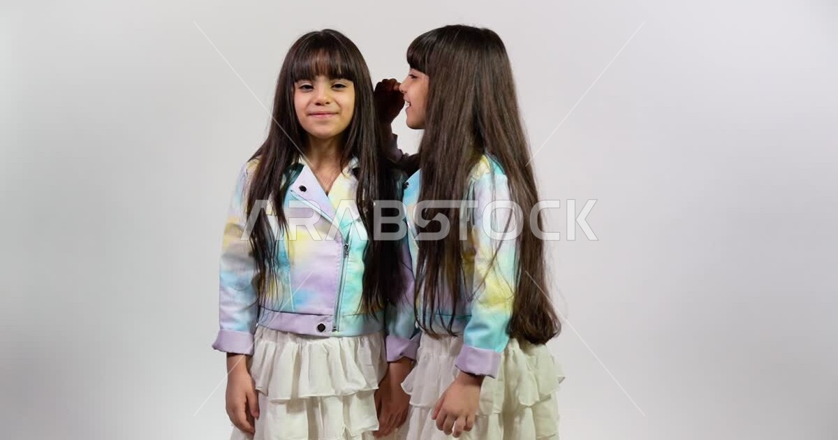 Portrait of two similar Saudi twin sisters, wearing beautiful and ...
