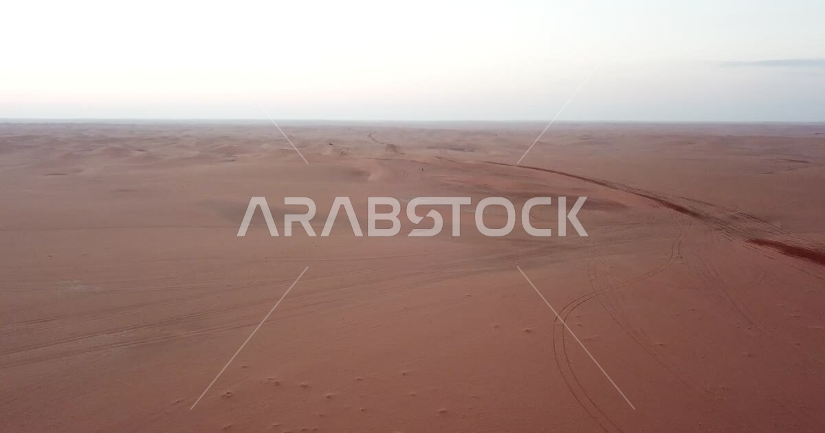 Soft golden sand, aerial photography of a racing car participating in ...