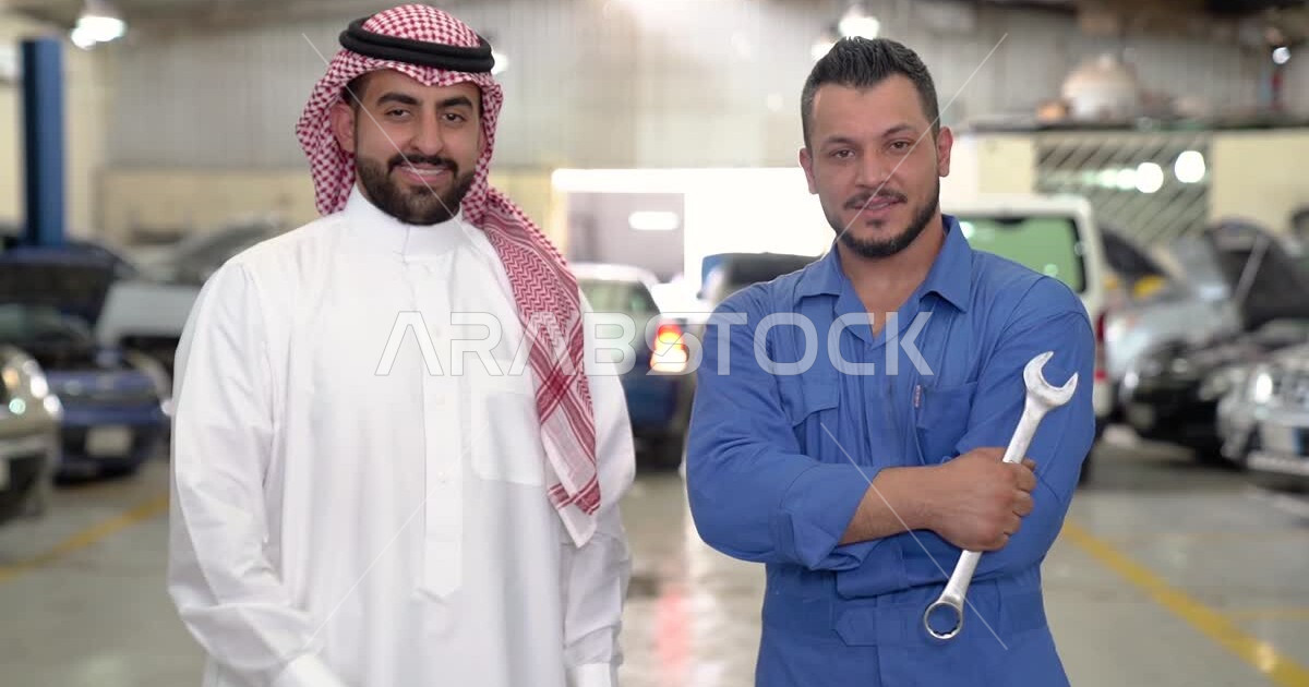 A Saudi Arab man stands with the mechanical engineer inside the auto ...