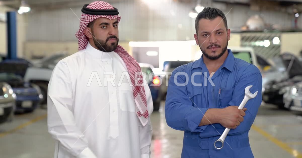 A Saudi Arab man stands with the mechanical engineer inside the auto ...