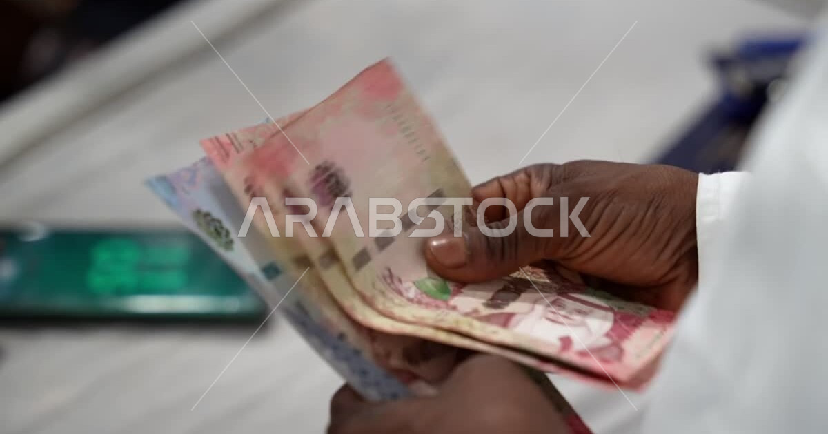Money trading and exchange, bill payment, close up of hands of Saudi ...