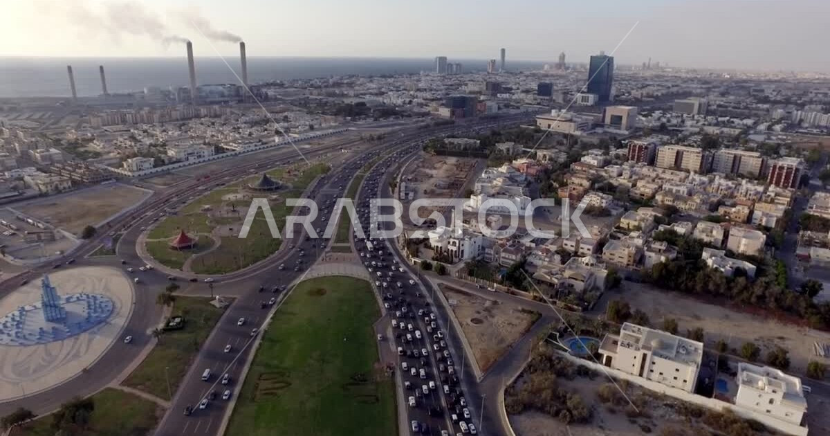 Drone footage of Jeddah main street roundabout, traffic on paved ...
