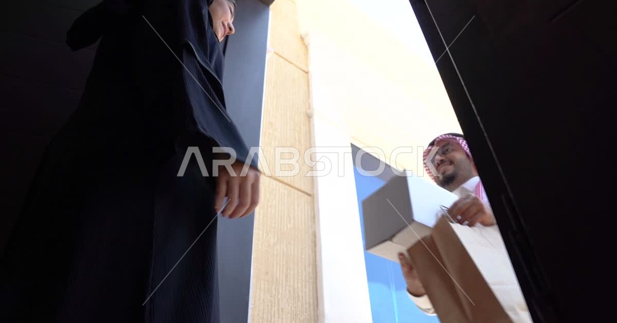 A young Saudi Arabian Gulf man works on delivering orders, delivering ...