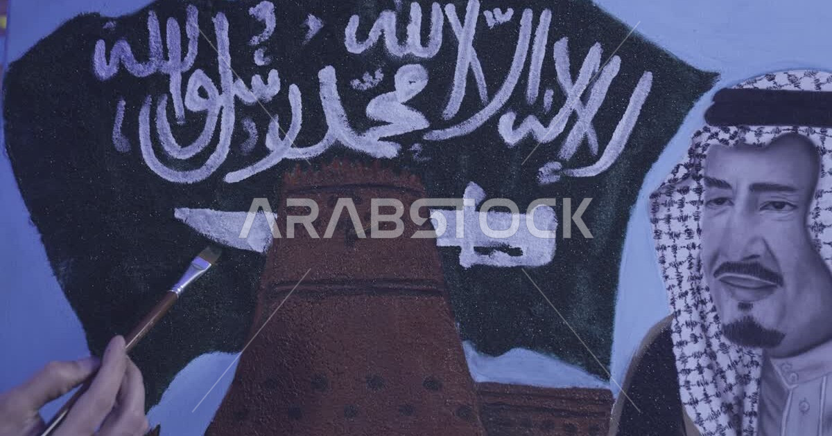 A Saudi Arabian Gulf artist wearing a painting apron is drawing and ...