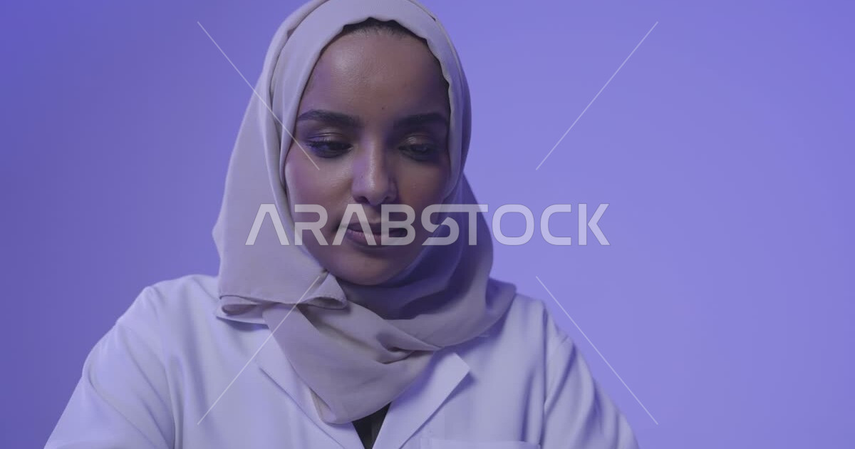 Veiled Saudi Arabian Gulf female pharmacist wearing white medical coat ...
