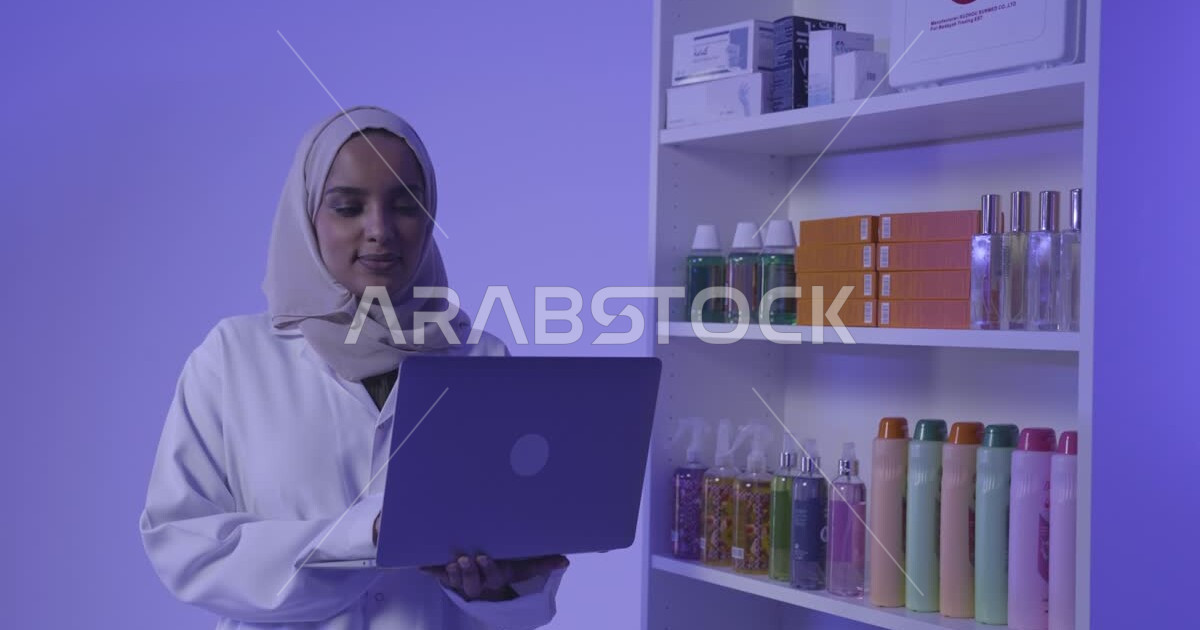 Checking the list of medications, veiled Saudi Arabian Gulf female ...