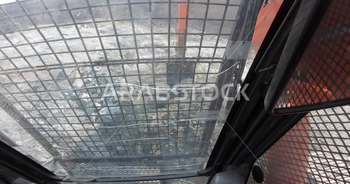 Excavator lifting and filling rubble during the day, the concept of ...