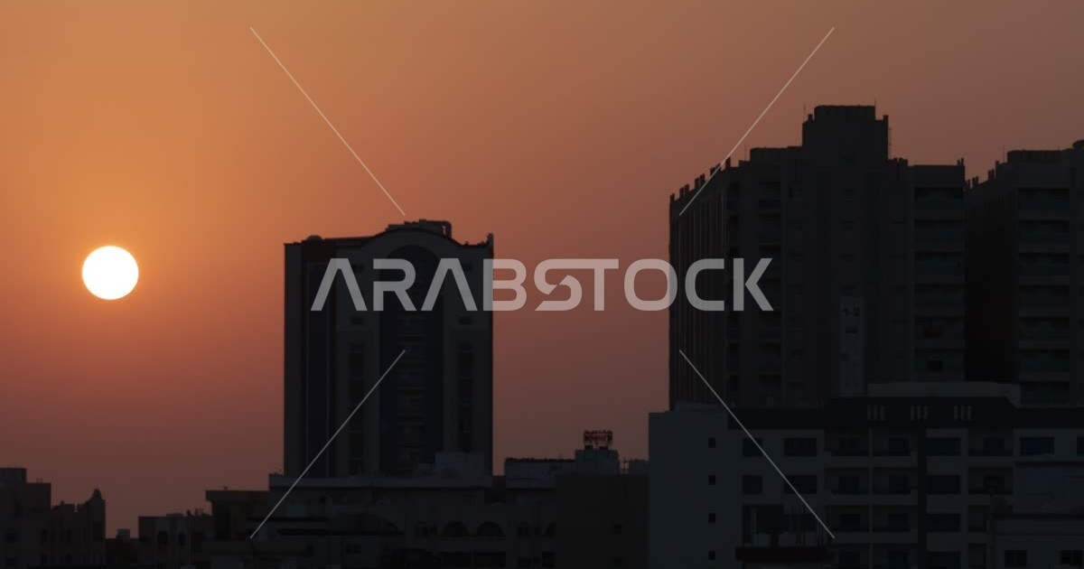 The view of the blazing sun disk in the sky, urban development in the ...