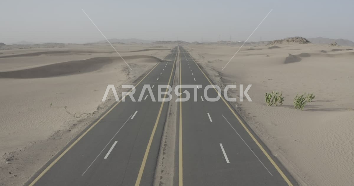 Soft sand dunes and hills, golden sand in desert areas, paved road ...